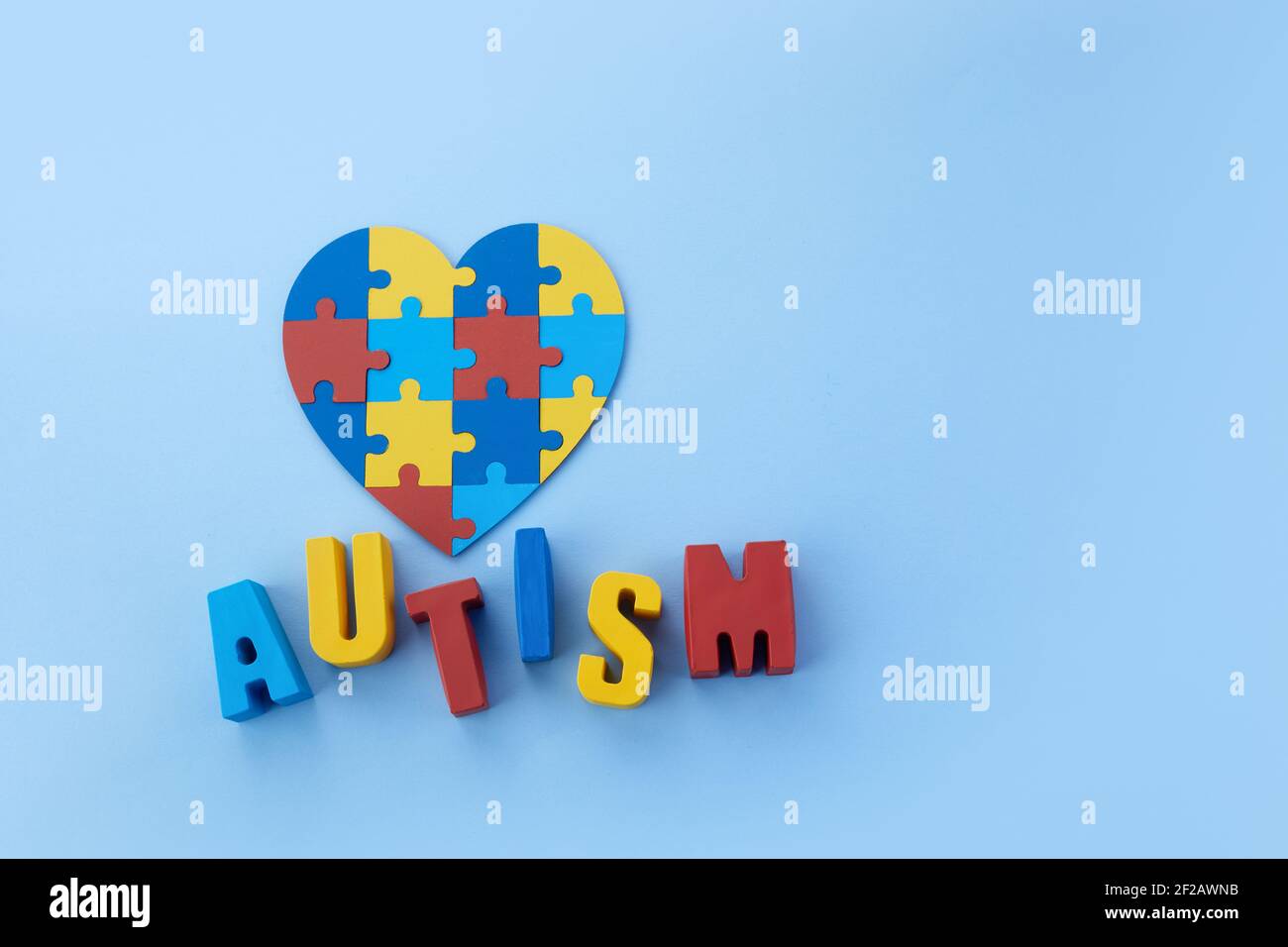 Autism awareness concept with puzzle shape of heart and word autism on ...