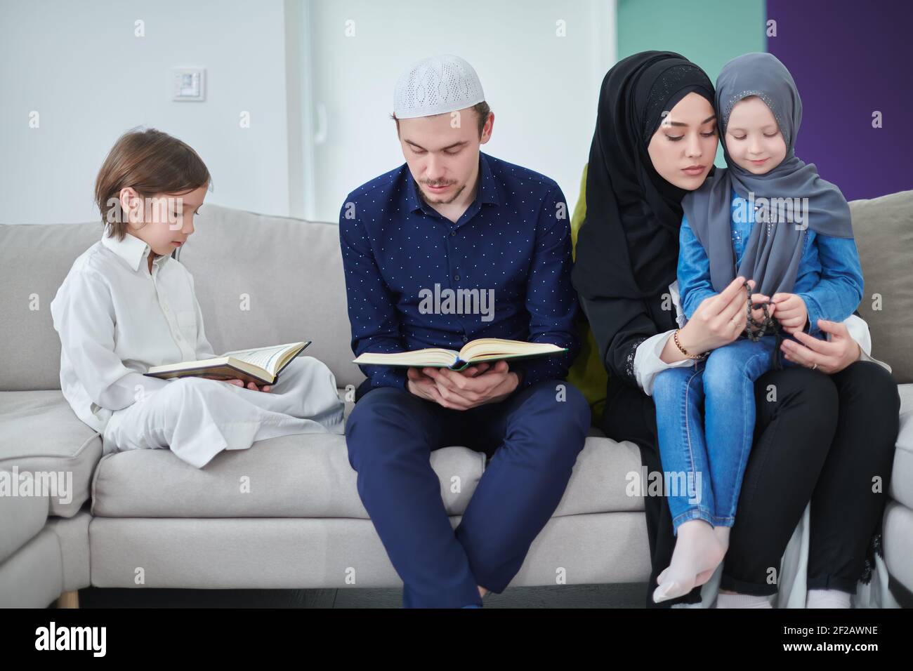 Young muslim family reading Quran during Ramadan Stock Photo - Alamy