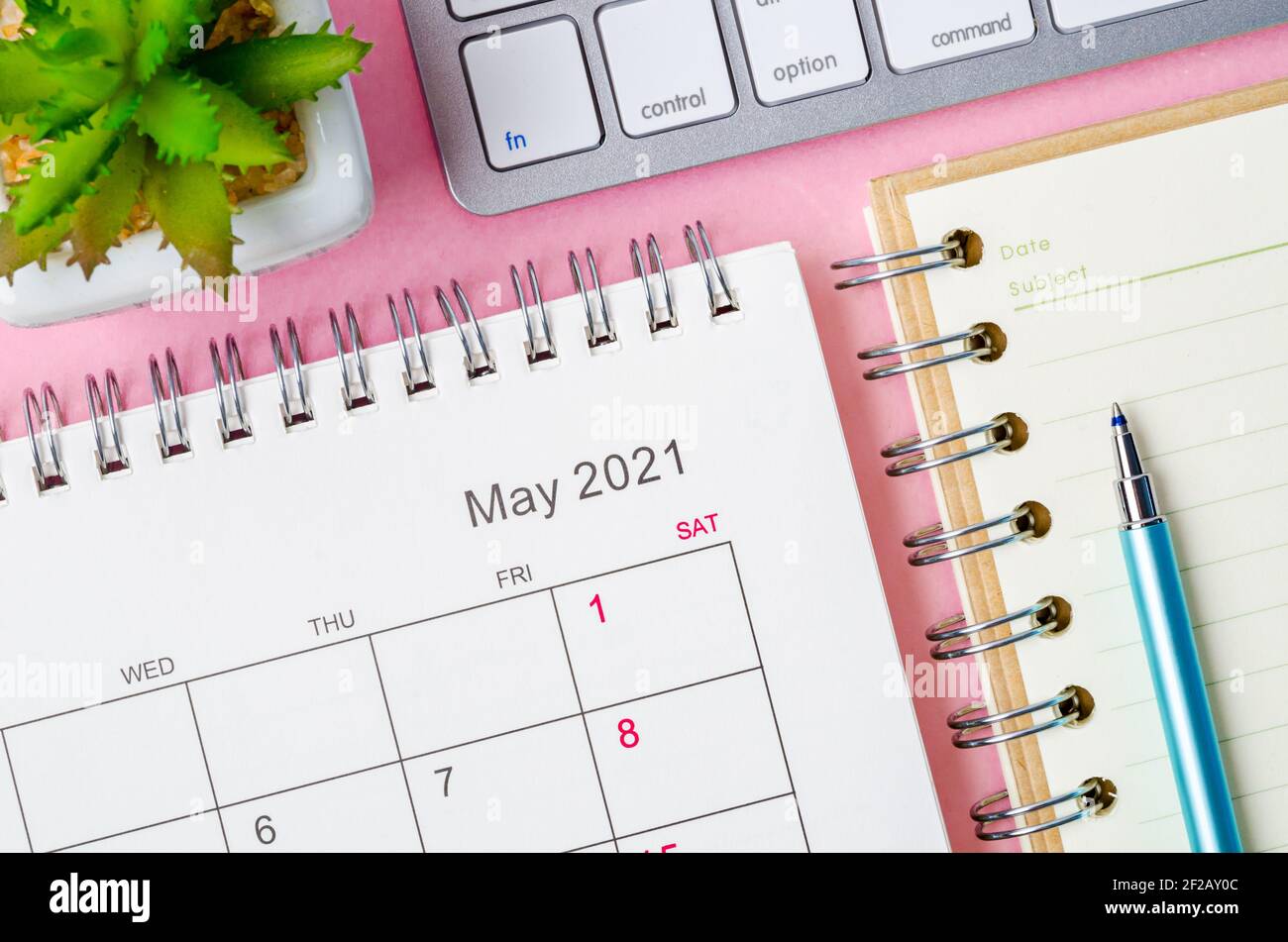 May 2021 calendar with note book on pink background Stock Photo - Alamy