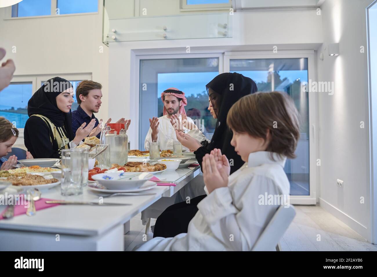 Muslim family making iftar dua to break fasting during Ramadan Stock ...