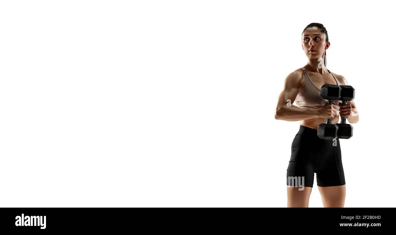 Dumbbells. Flyer. Caucasian professional female athlete training ...