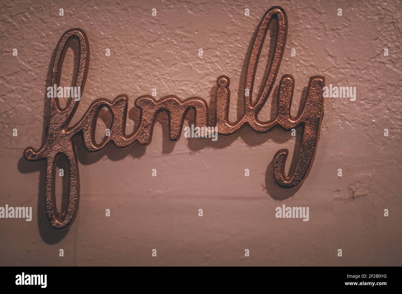 A view of lettering of the word "family" with golden letters on a ...