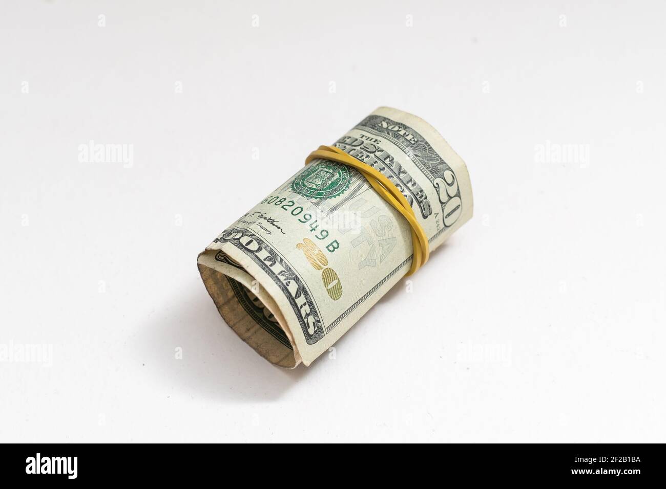 Roll of money isolated on white background Stock Photo - Alamy