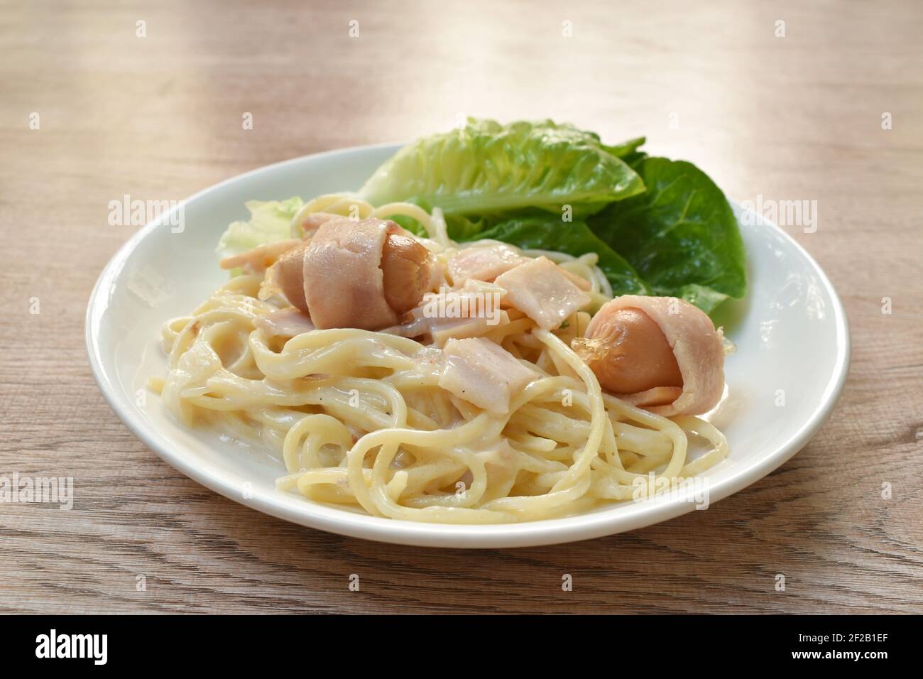 spaghetti carbonara topping slice ham pork and fresh cos lettuce ...