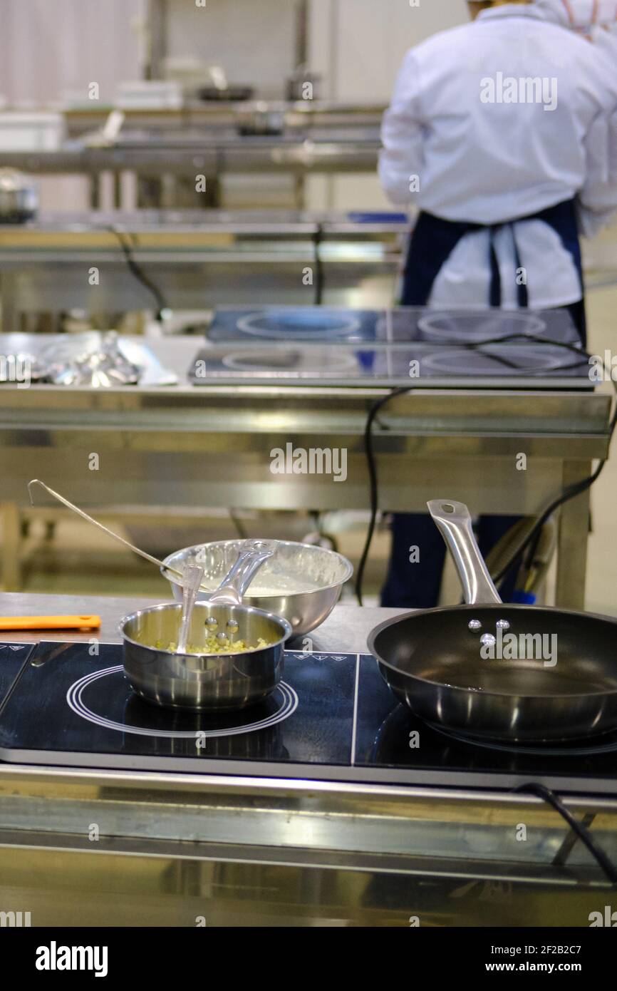 Cooking in the kitchen of restaurants and cafes using electric stoves ...