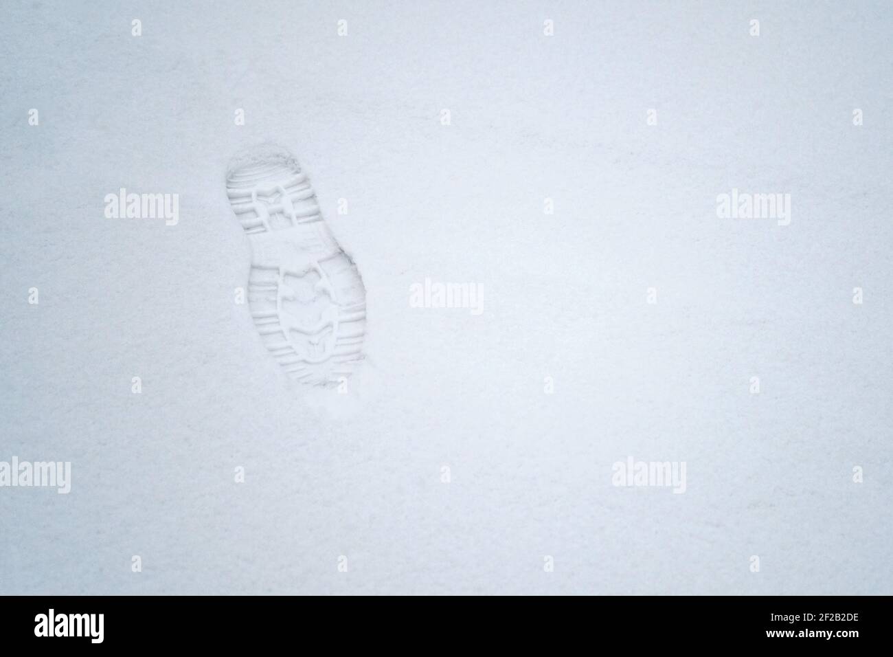 Man footprint on white winter snow. Track in snow. Flat lay overhead ...