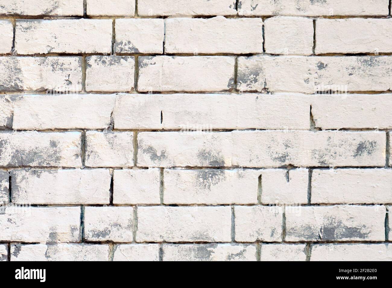 The texture of the walls are of white brickwork with gray seats. White ...