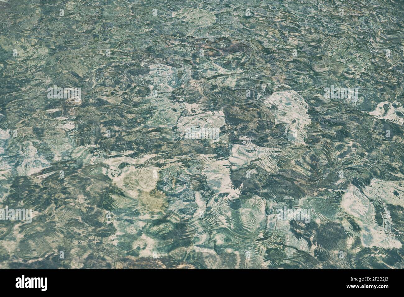 Clear sea water texture, top view of the rocky bottom. Underwater view ...
