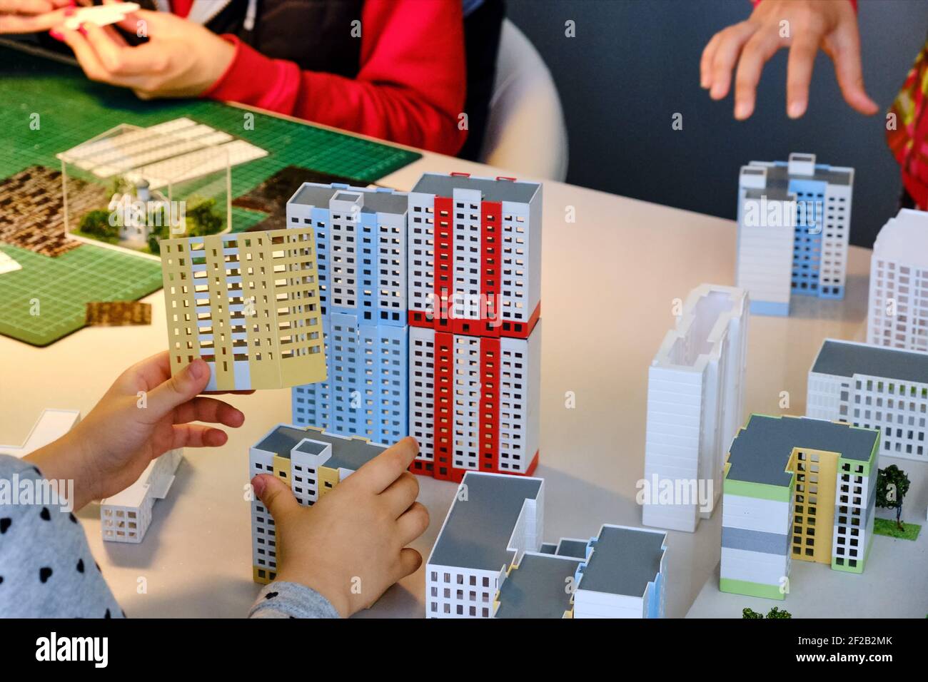 Kids playing in the city and building houses, close up background Stock ...