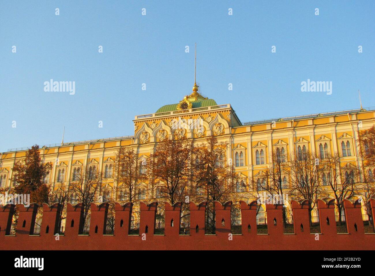 The Grand Kremlin Palace against the blue sky, behind the wall of the ...