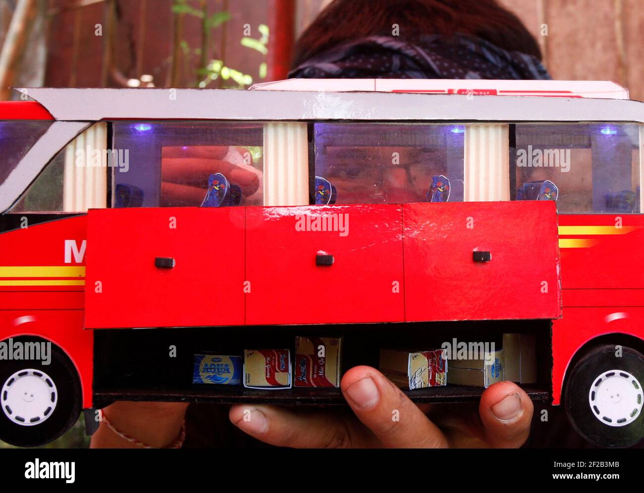 A man works to create a replica miniature, 3D-printed Indonesian bus ...