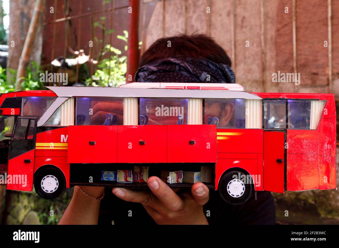 A man works to create a replica miniature, 3D-printed Indonesian bus ...
