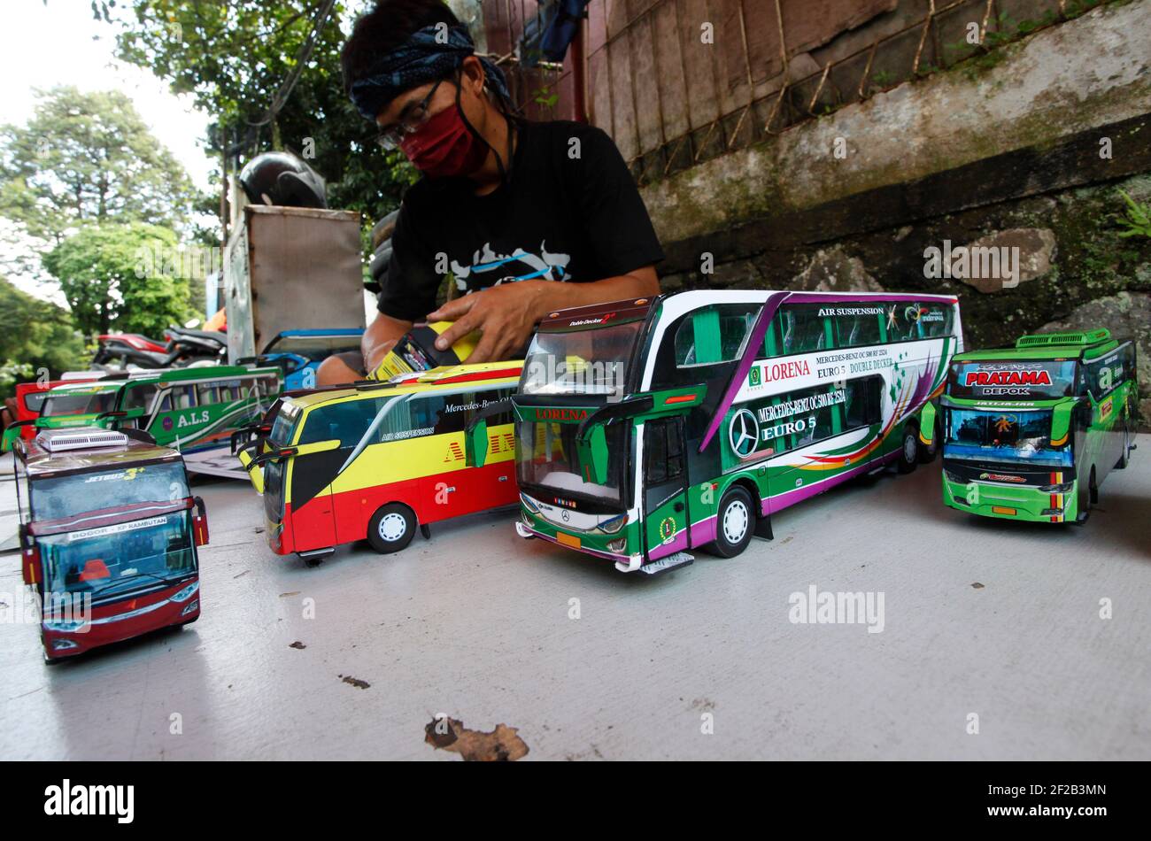 A man works to create a replica miniature, 3D-printed Indonesian bus ...