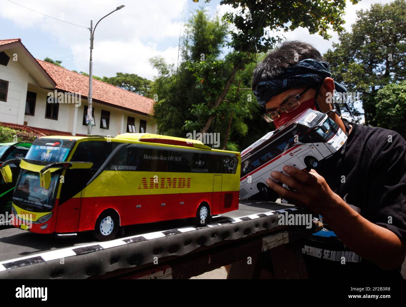 A man works to create a replica miniature, 3D-printed Indonesian bus ...