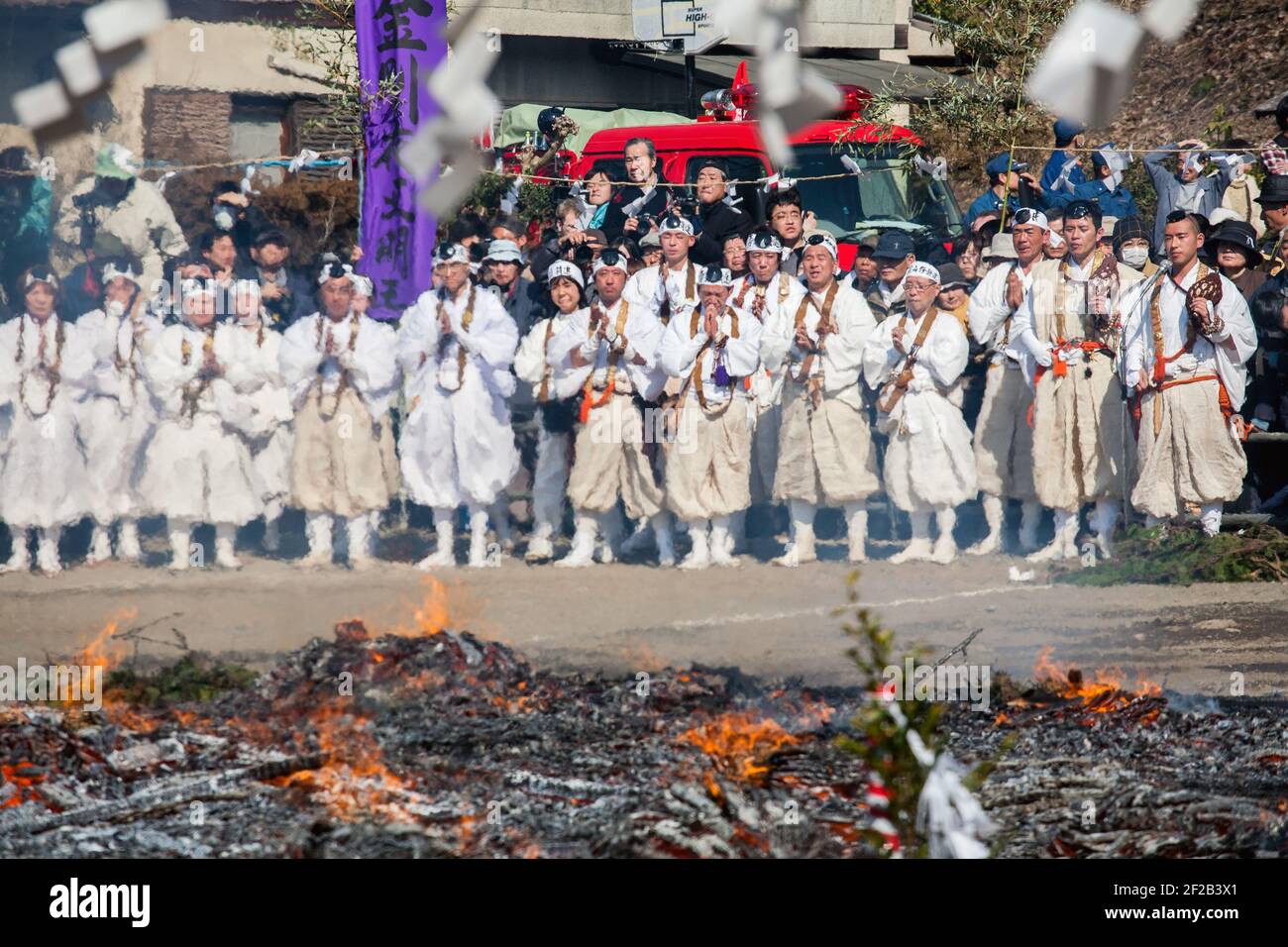 Shugenja Buddhist pilgrims watching the bonfire flames dying at the ...
