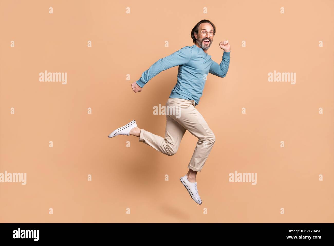 Full length photo portrait of happy man running jumping up isolated on ...
