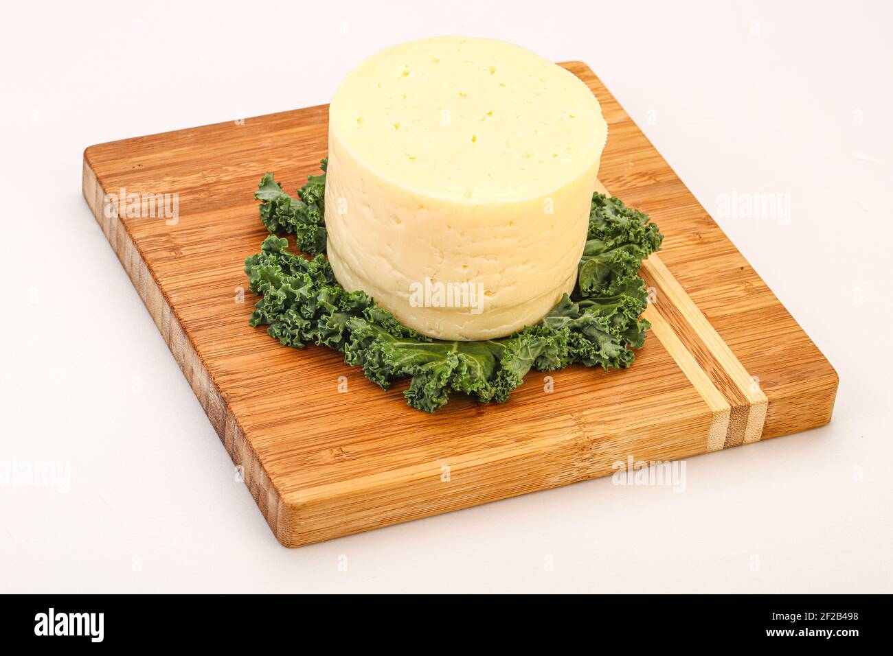 Yellow round dairy soft cheese piece Stock Photo - Alamy