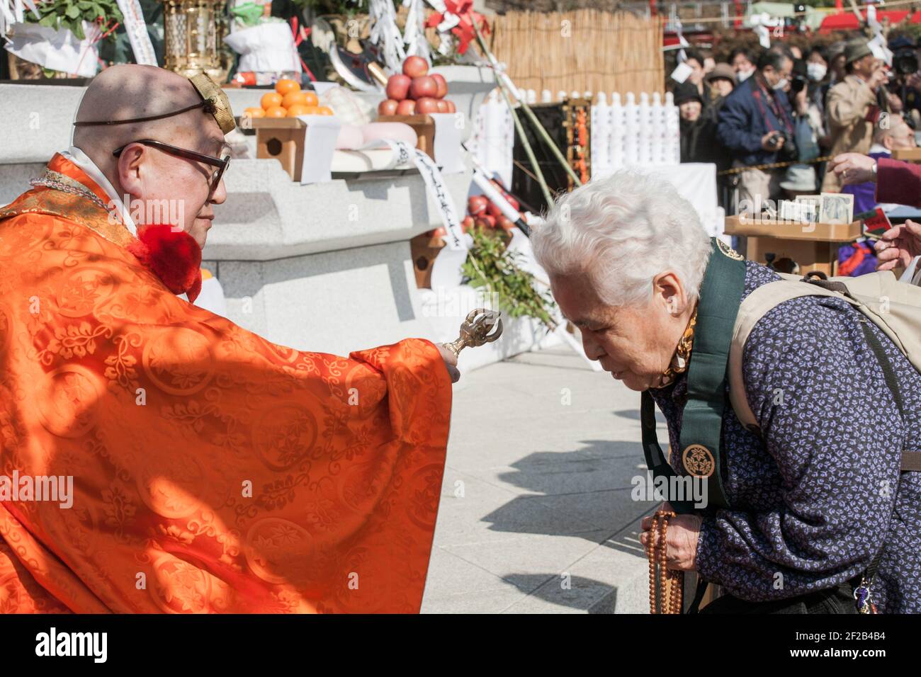 Buddhist Shugenja Priest giving blessings to an elderly Japanese lady ...