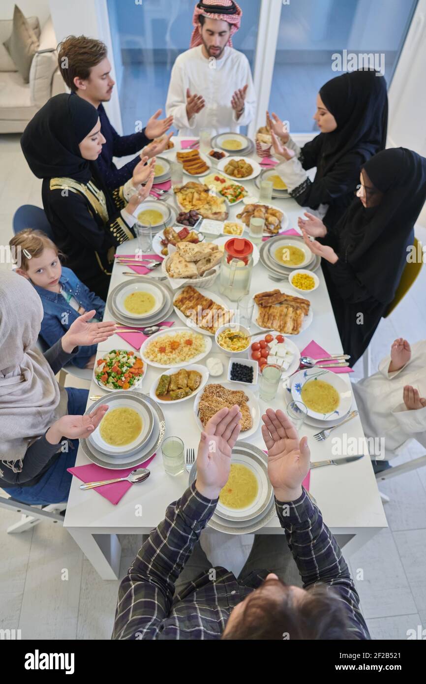 Muslim family making iftar dua to break fasting during Ramadan Stock ...