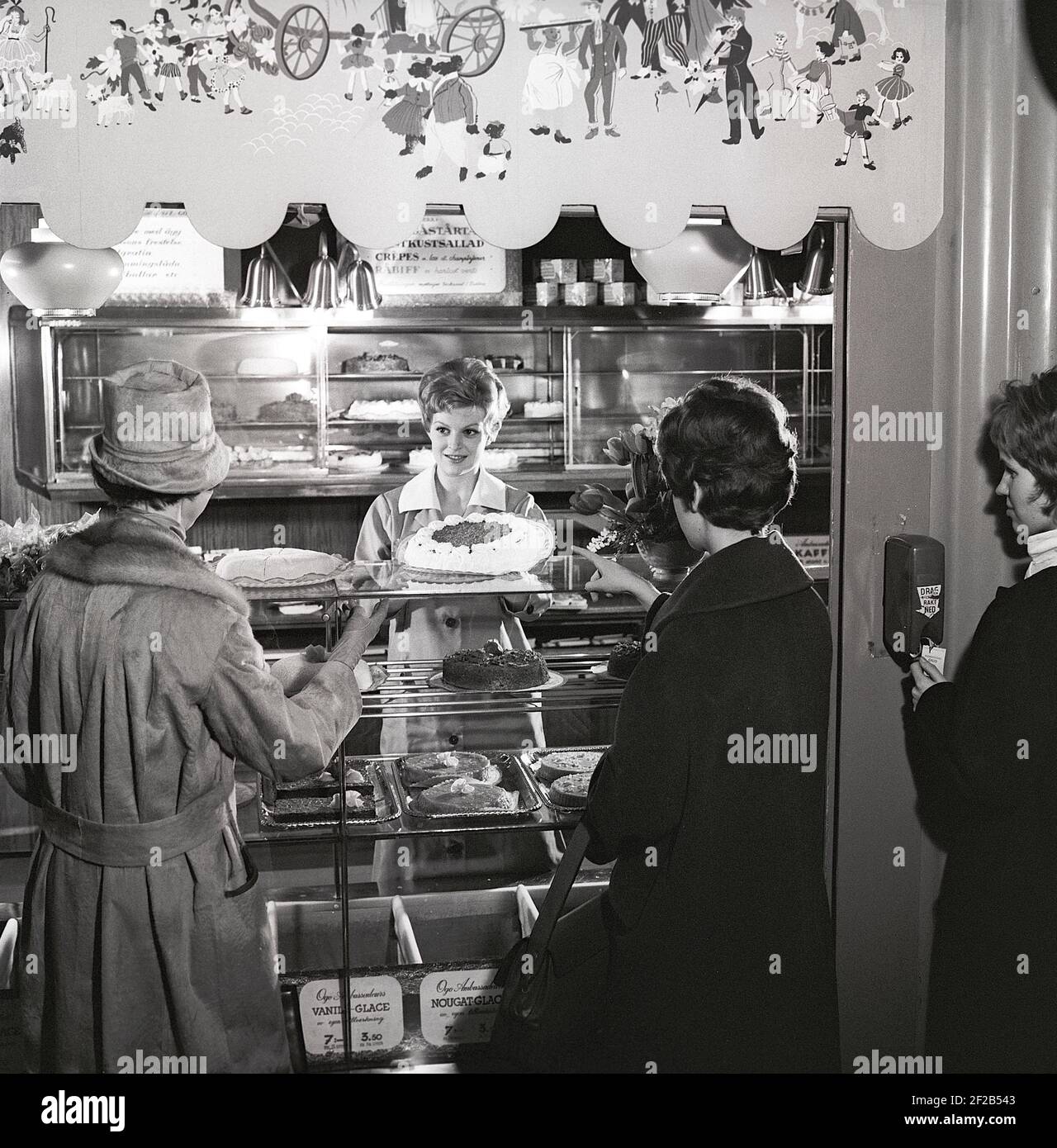 1960s coffee shop. Two women are standing in front of the counter that ...