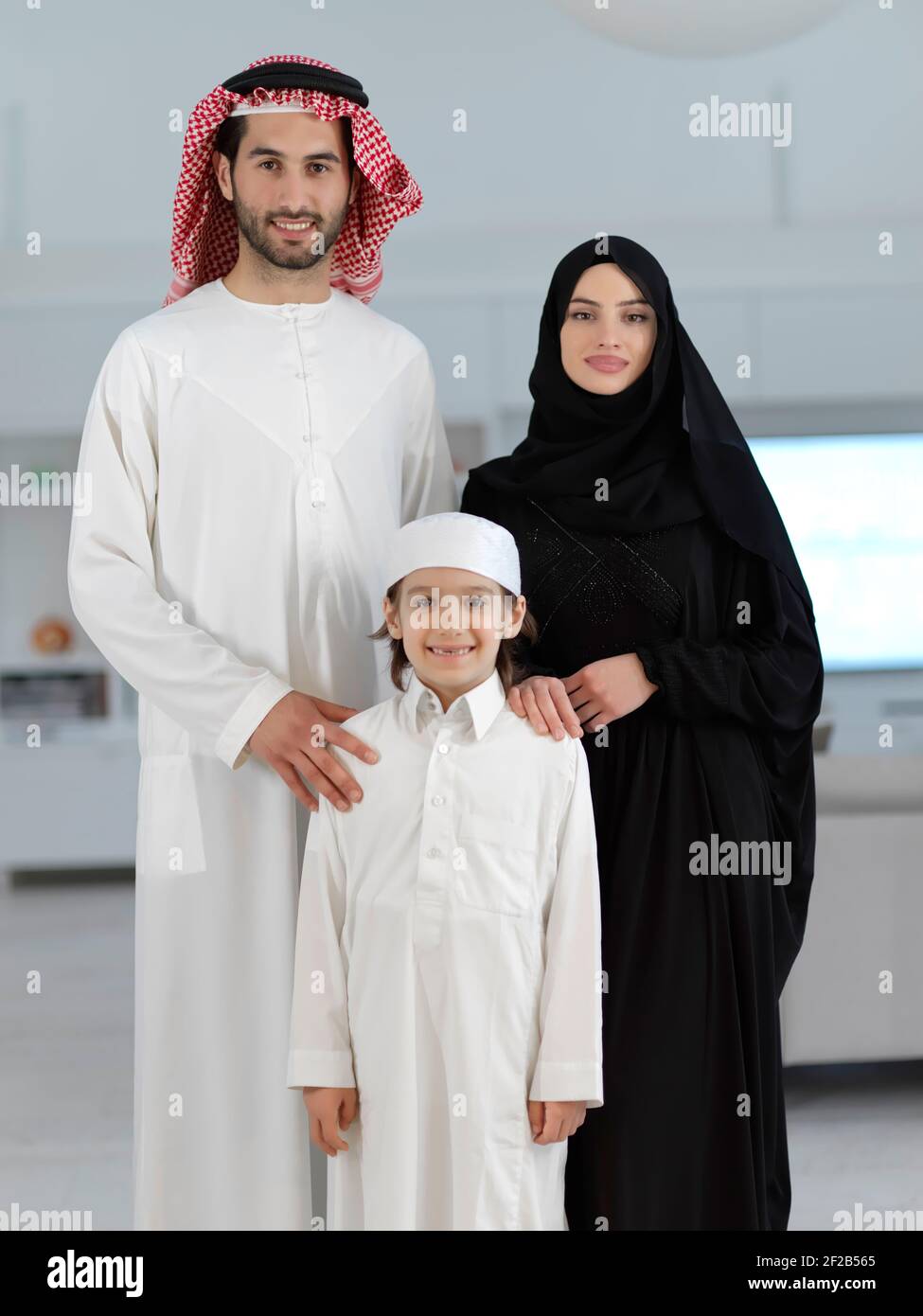 young arabian muslim family wearing traditional clothes at their modern ...