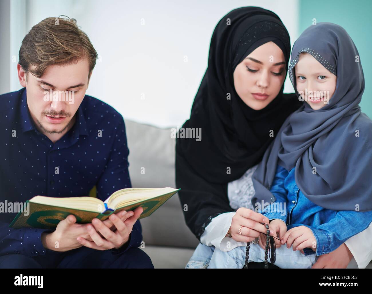 Young muslim family reading Quran during Ramadan Stock Photo - Alamy