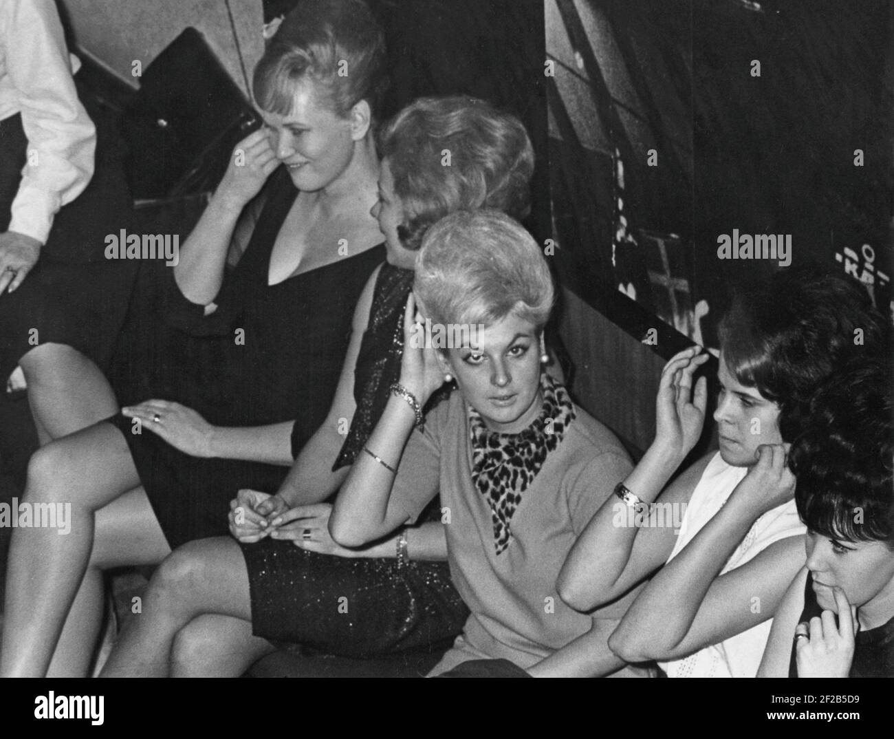 1960s fashion models. A girls night out. The typical hairdo of the ...