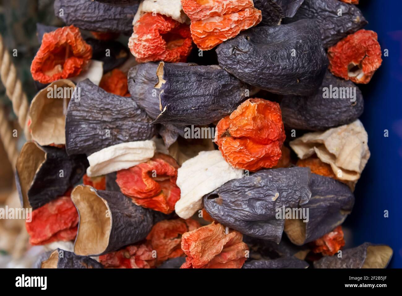 Dried vegetables hanging in a local bazaar. Dried food prepared for the ...