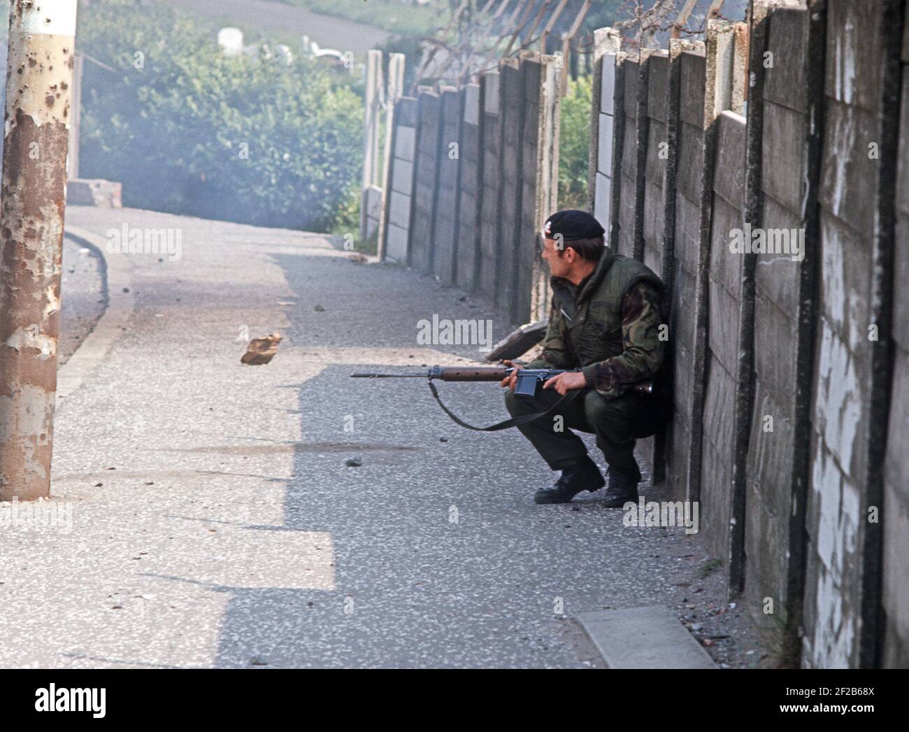 BELFAST, UNITED KINGDOM - JUNE 1972. British Army Soldier taking cover ...