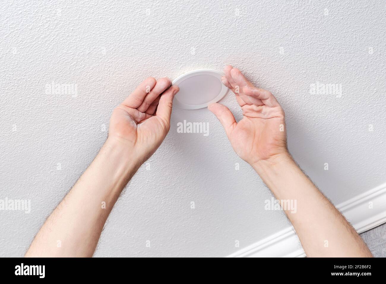 Hand installing led light bulb hi-res stock photography and images - Alamy