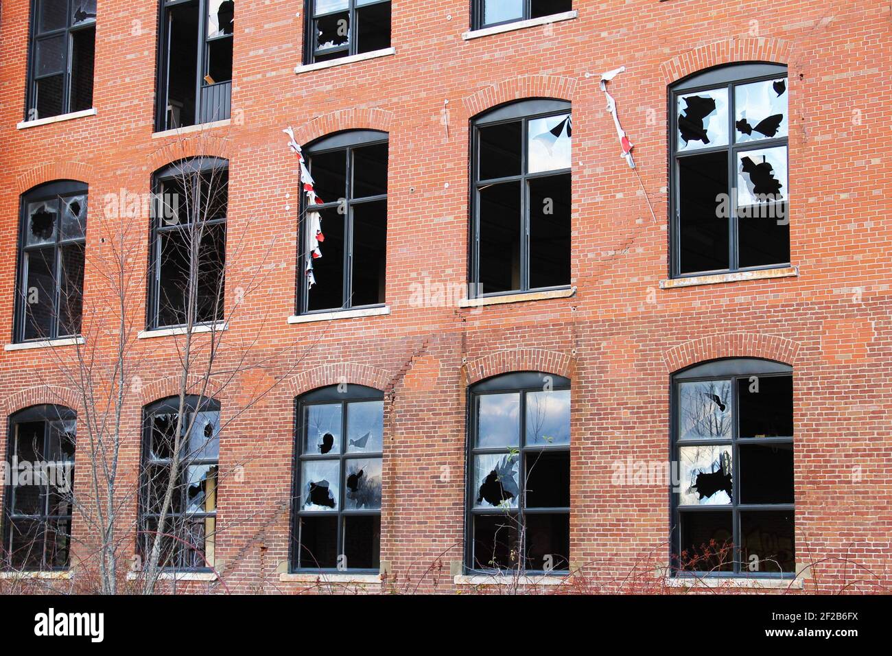 Rows of broken windows in a brick wall, in an old, abandoned building Stock Photo - Alamy