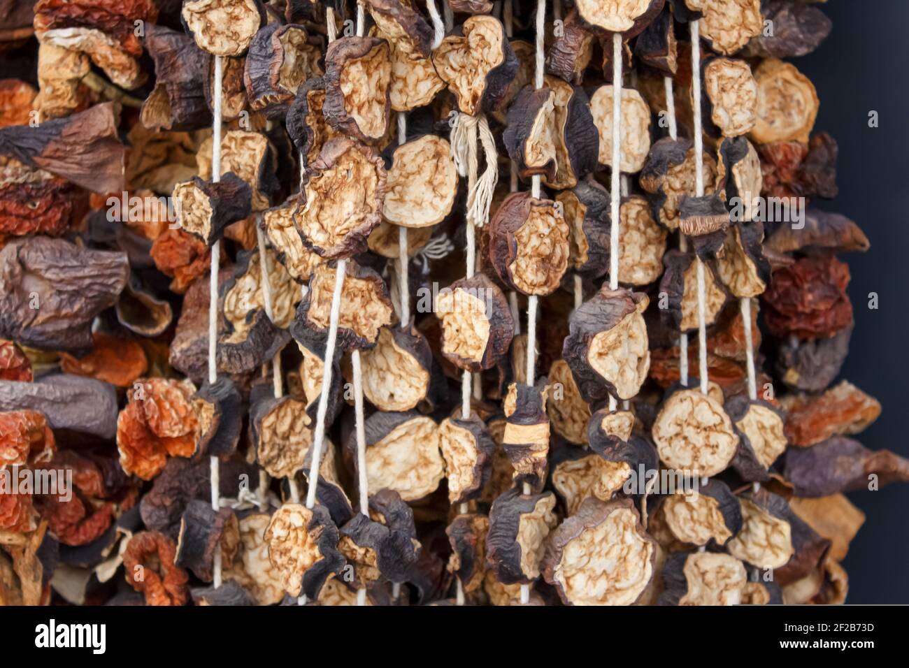 Dried vegetables hanging in a local bazaar. Dried food prepared for the ...