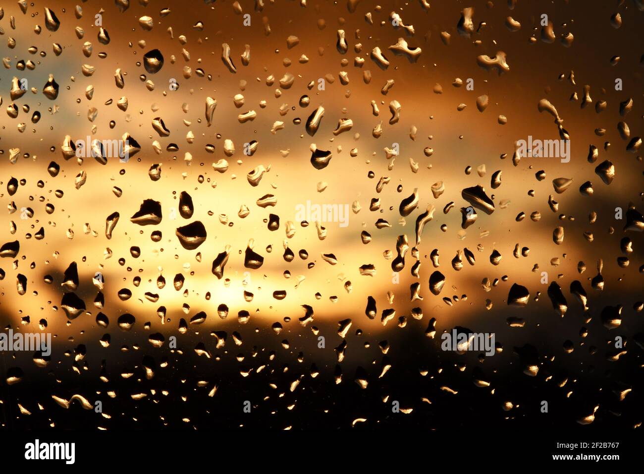 Sunset colours through a rain splattered glass window. Somerset Stock ...