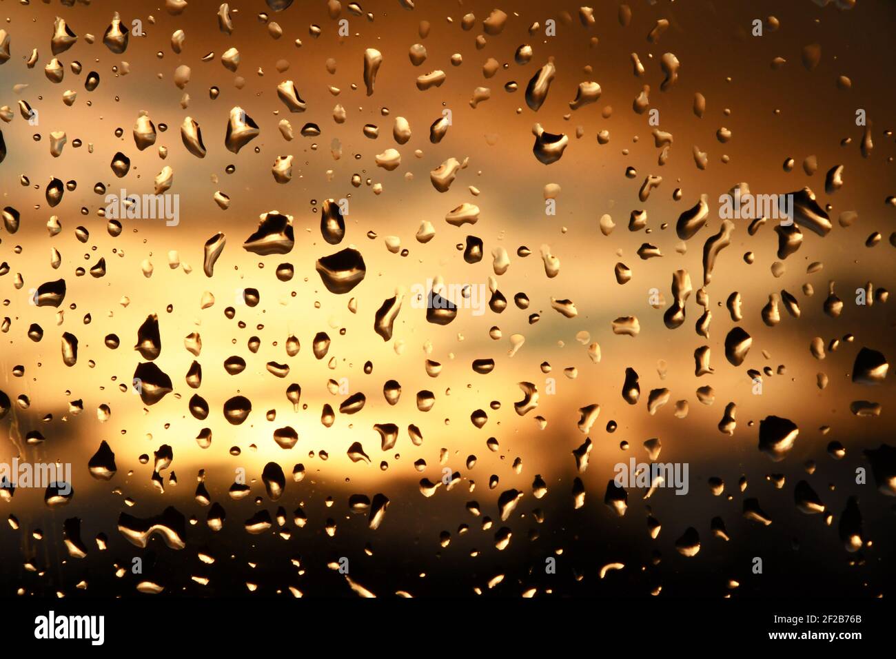 Sunset colours through a rain splattered glass window. Somerset Stock ...