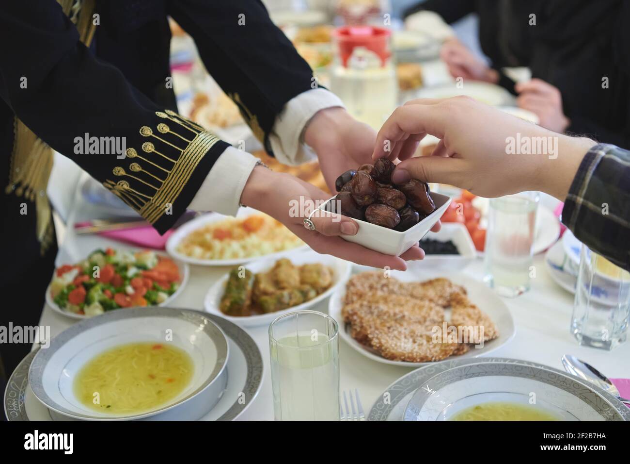 Muslim family starting iftar with dates during Ramadan Stock Photo - Alamy