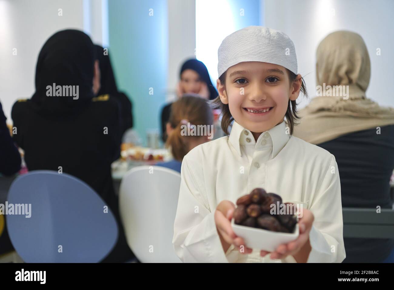 Arabian kid in the traditional clothes during iftar Stock Photo - Alamy