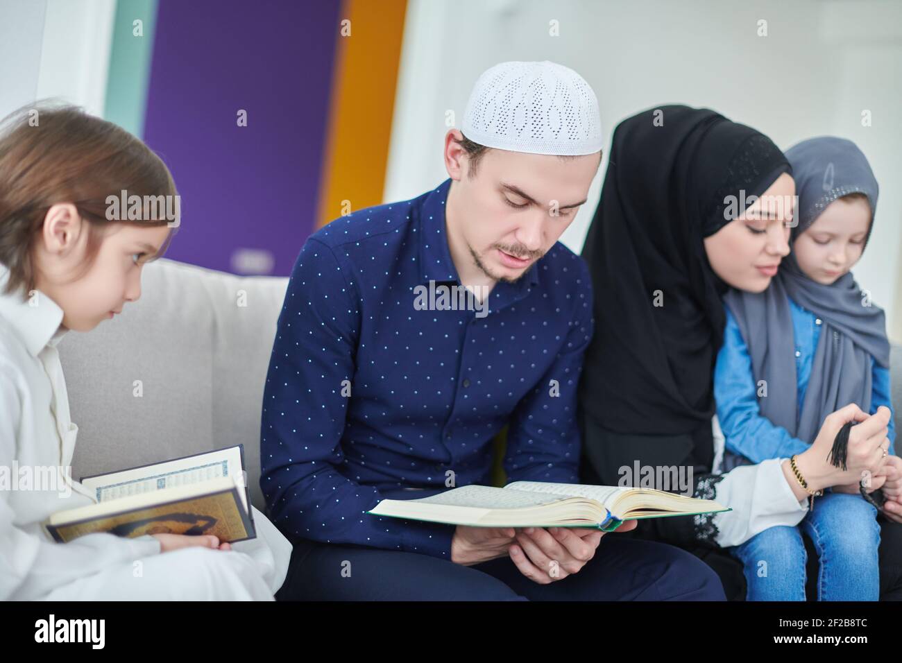 Young muslim family reading Quran during Ramadan Stock Photo - Alamy