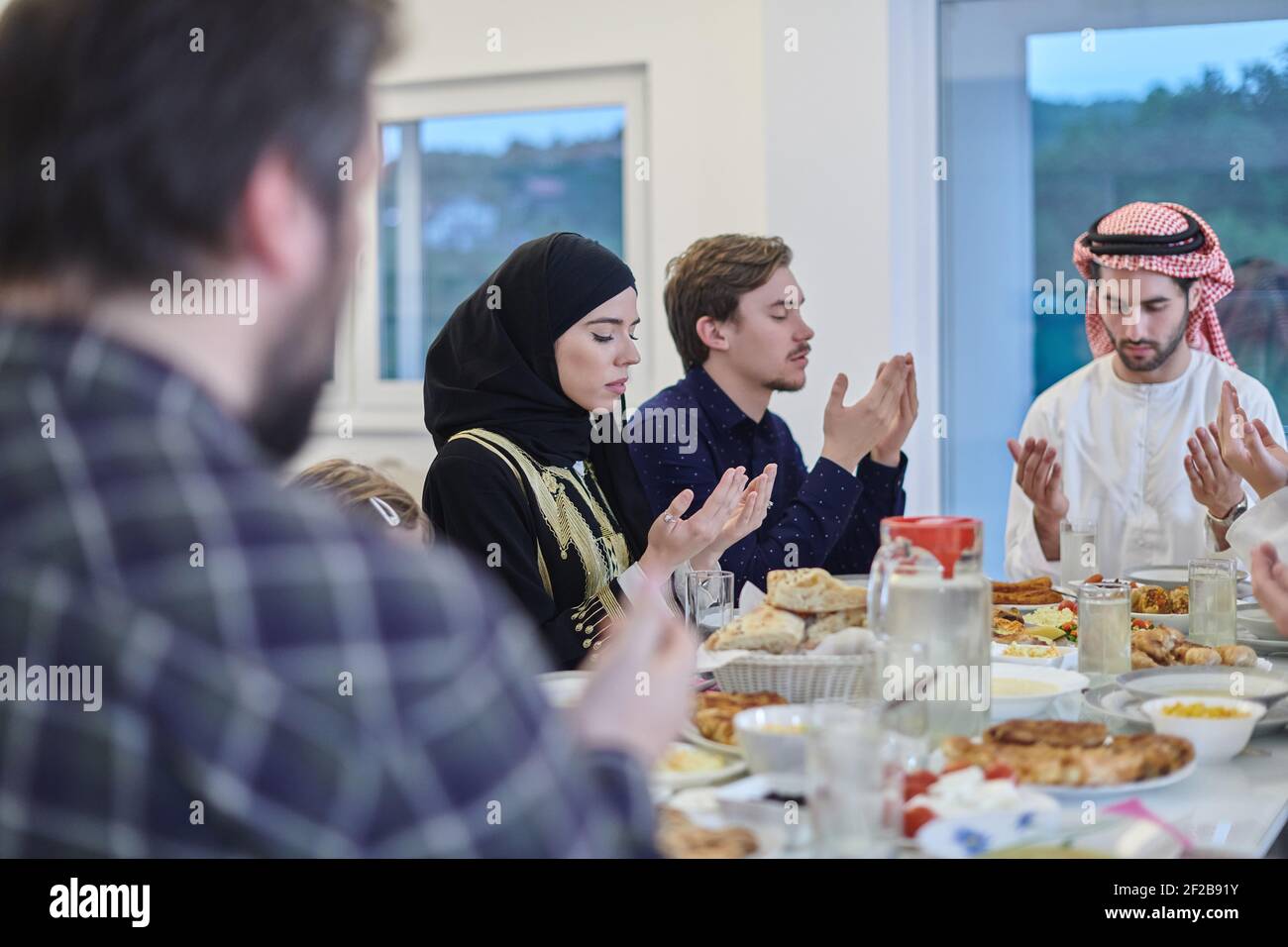 Muslim family making iftar dua to break fasting during Ramadan Stock ...