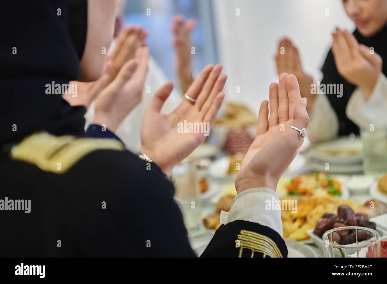 Muslim family making iftar dua to break fasting during Ramadan Stock ...