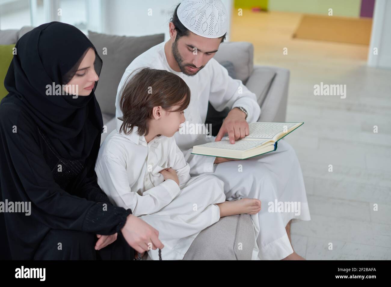 Young muslim family reading Quran during Ramadan Stock Photo - Alamy