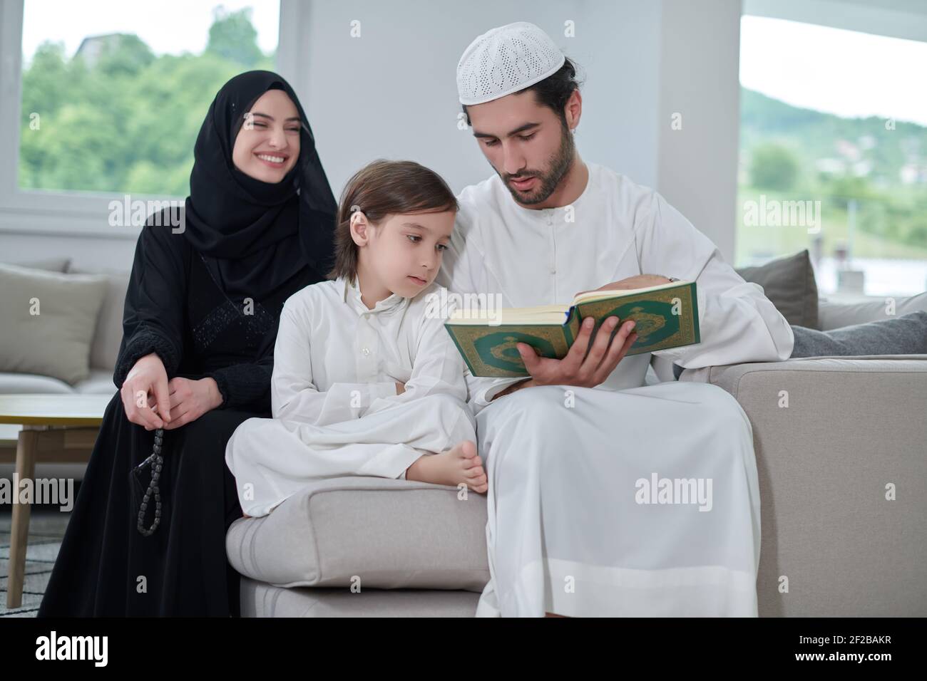 Young muslim family reading Quran during Ramadan Stock Photo - Alamy