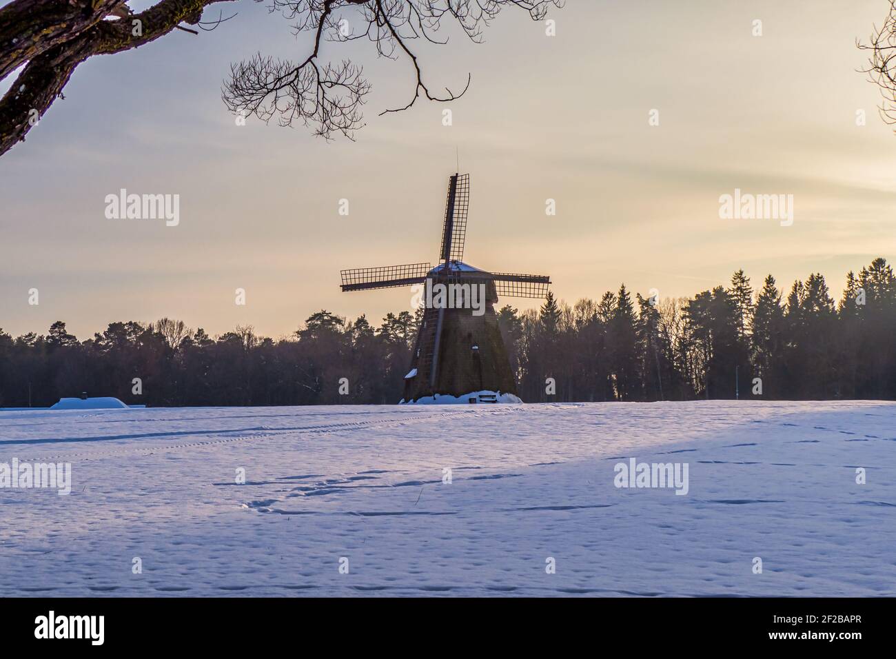 Windmill Covered with Snow at Sunset Stock Photo - Alamy