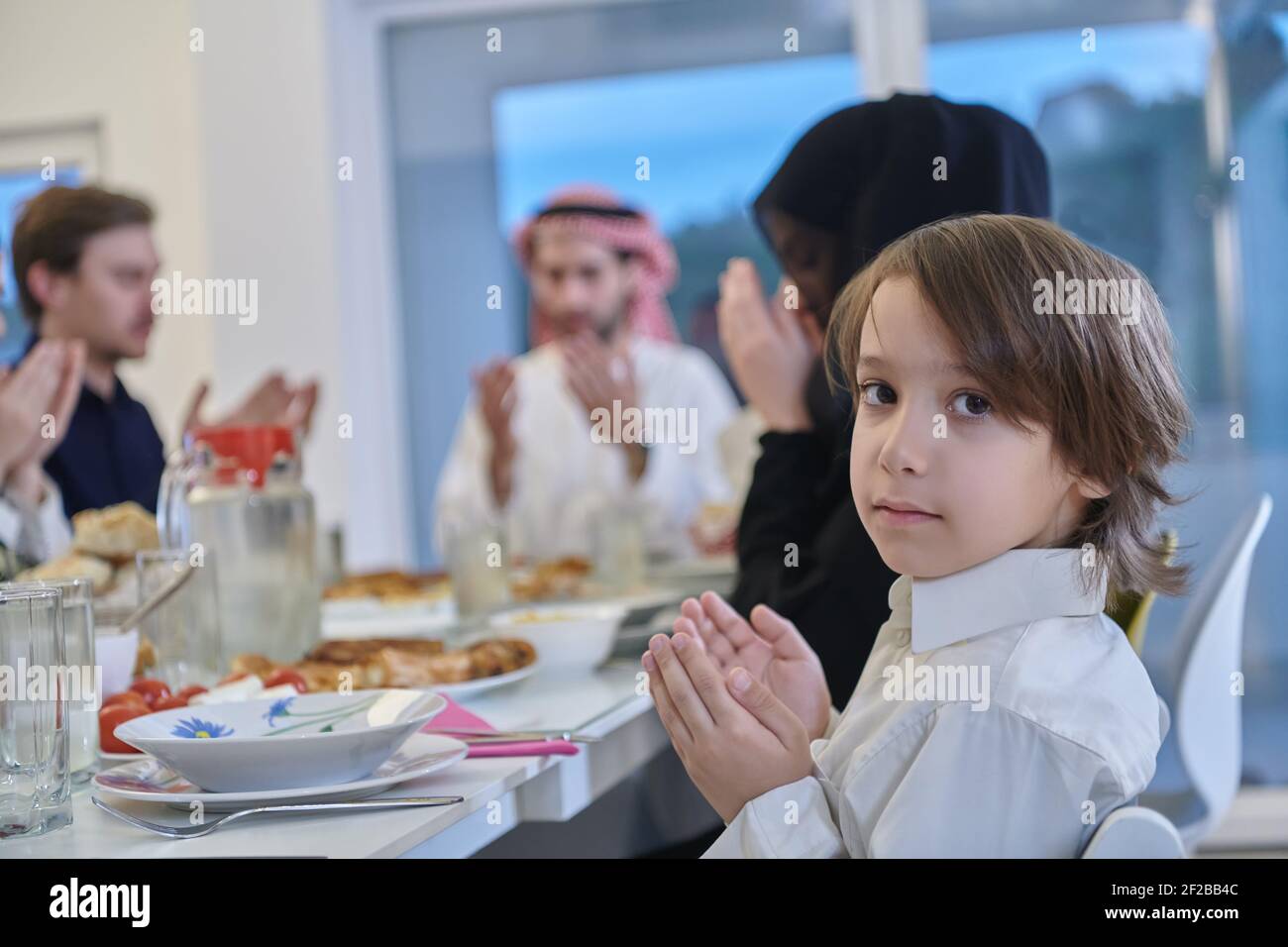 Muslim family making iftar dua to break fasting during Ramadan Stock ...