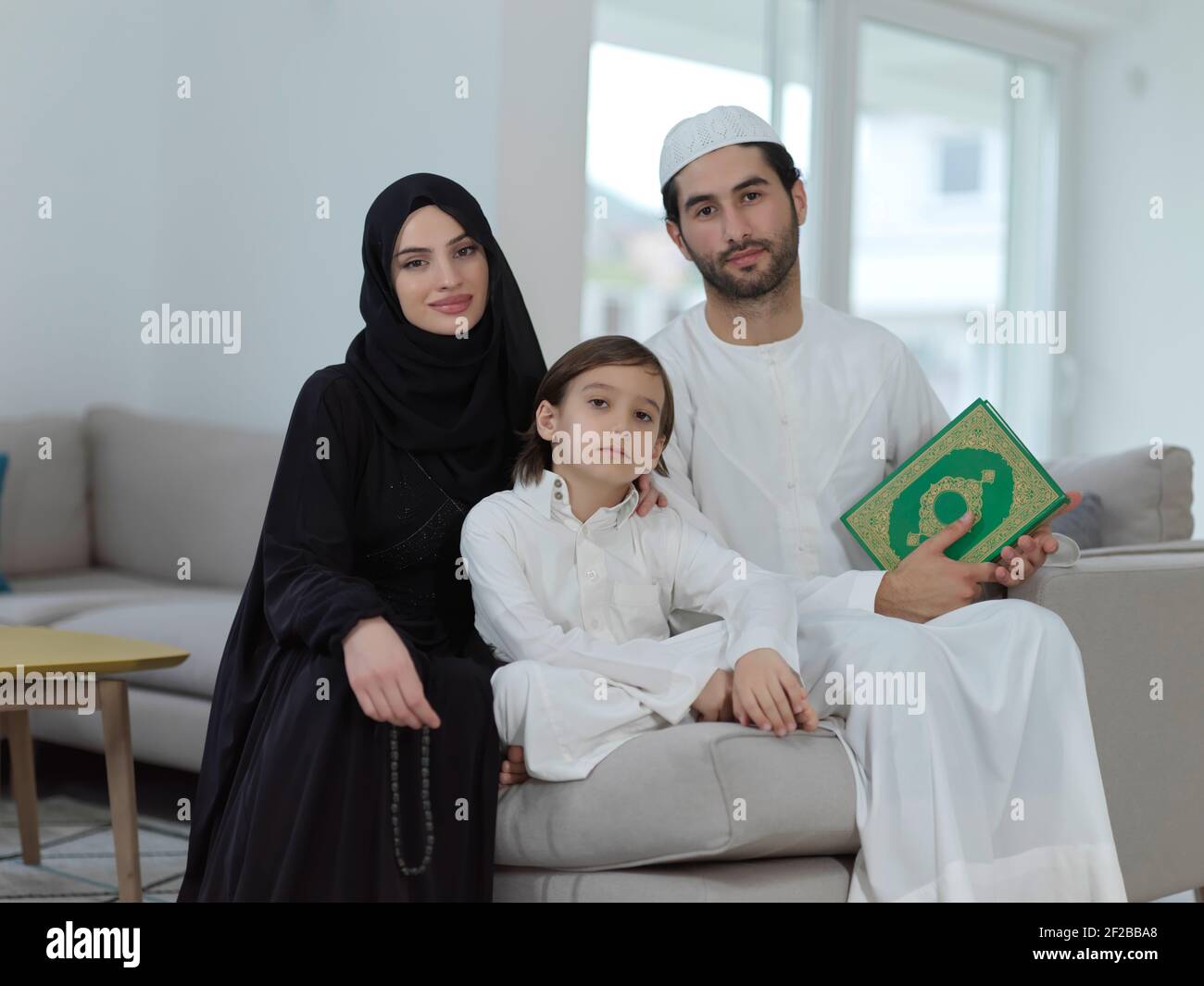 Young muslim family reading Quran during Ramadan. Parents and son ...