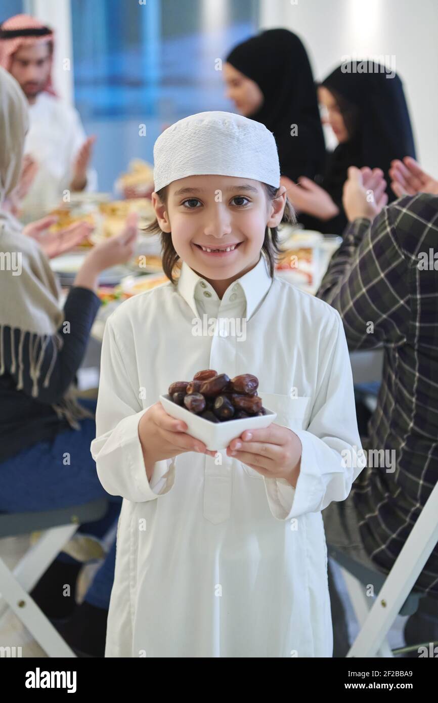Arabian kid in the traditional clothes during iftar Stock Photo - Alamy