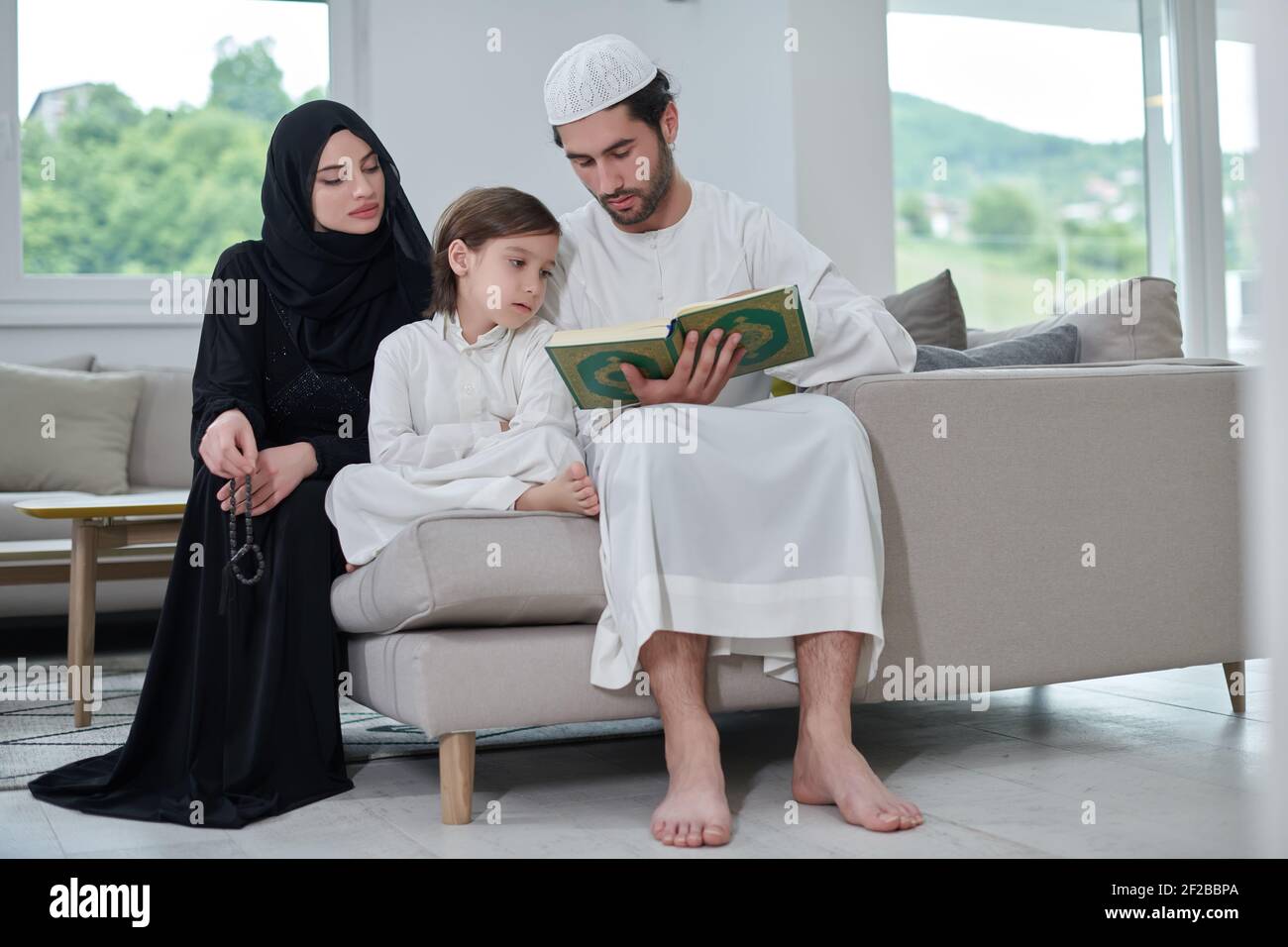 Young muslim family reading Quran during Ramadan Stock Photo - Alamy