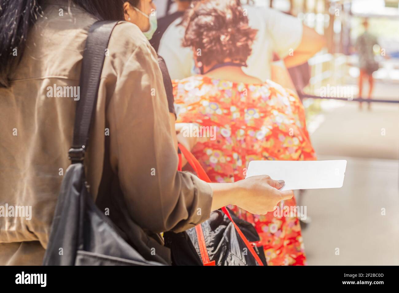Passengers hand holding boarding pass queueing for departure Stock ...