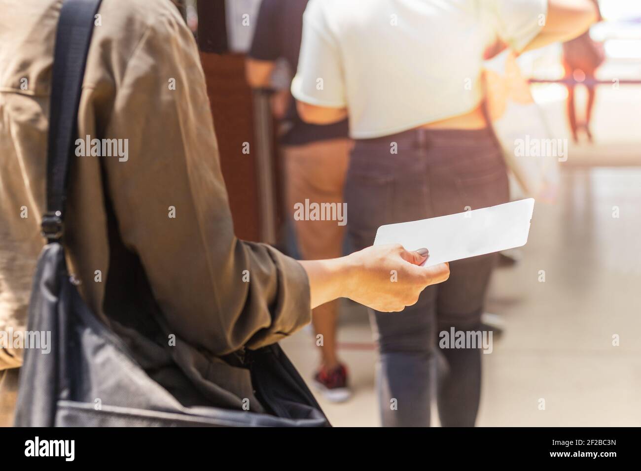 Passengers hand holding boarding pass queueing for departure Stock ...