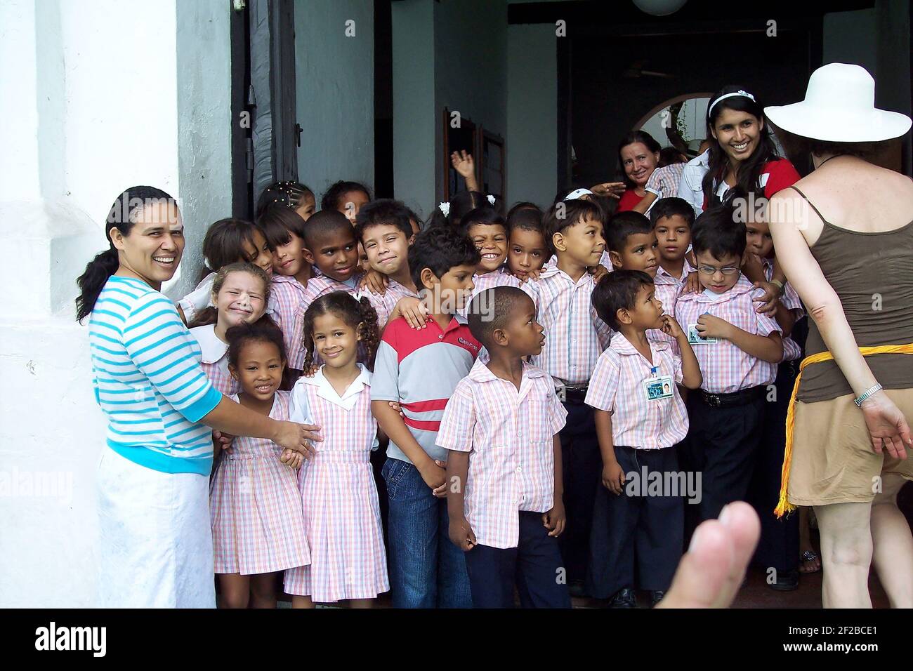 Large group of school children and their teacher on street hi-res stock ...
