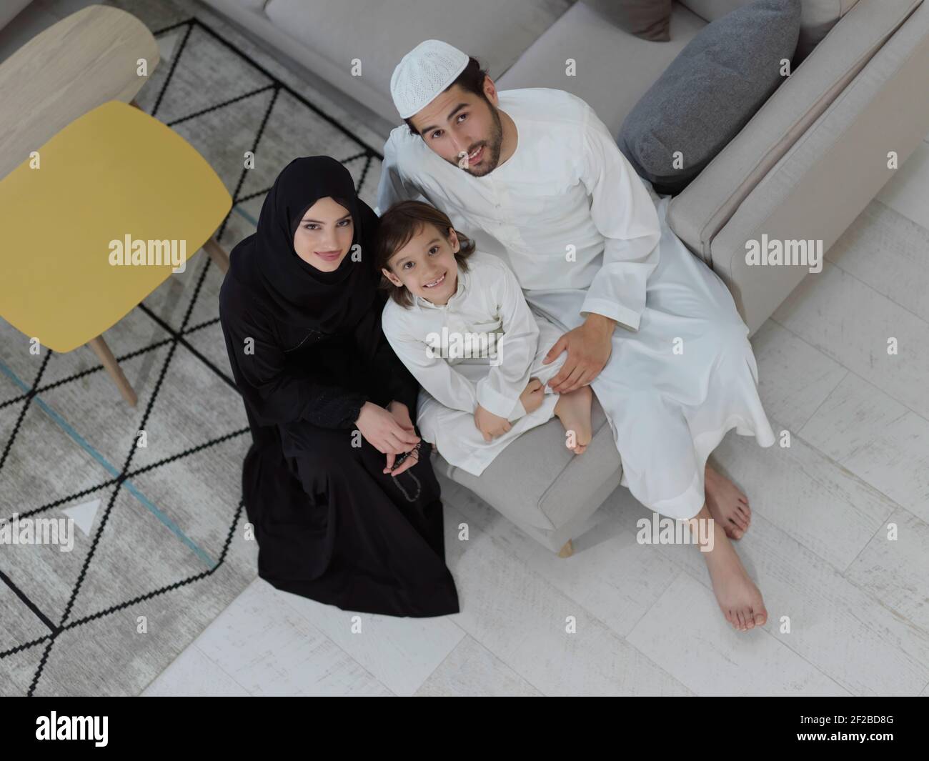 Top view of young arabian muslim family wearing traditional clothes at ...